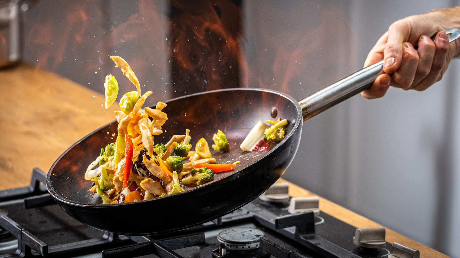 The Easy Tip For Tossing Food In A Wok Like A Pro