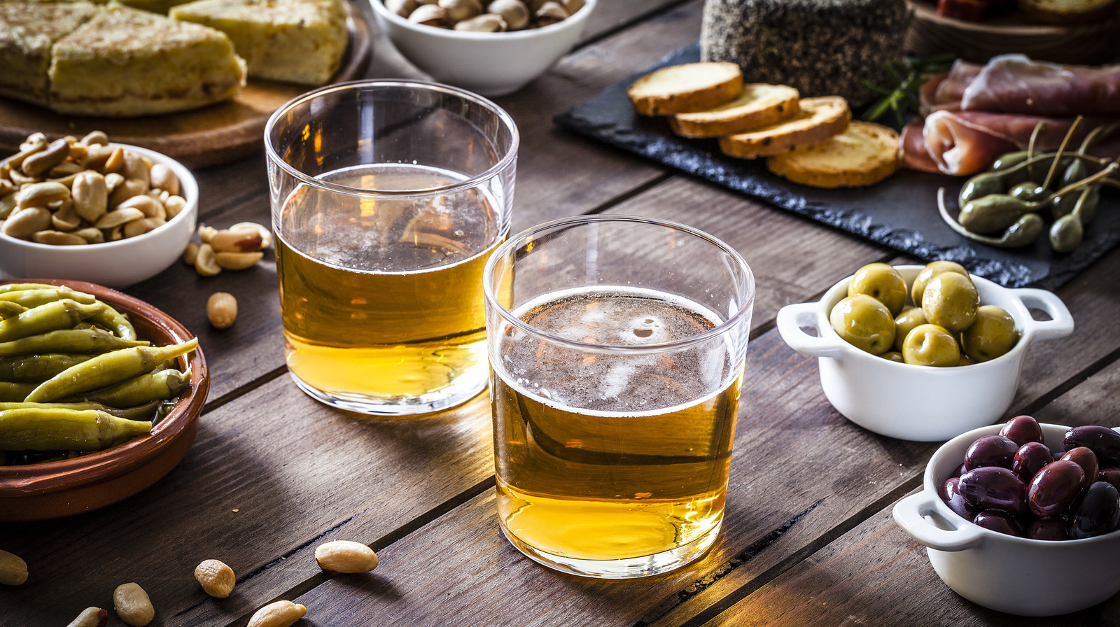 The Sneaky Reason Salty Snacks Are Offered Alongside Drinks At The Bar