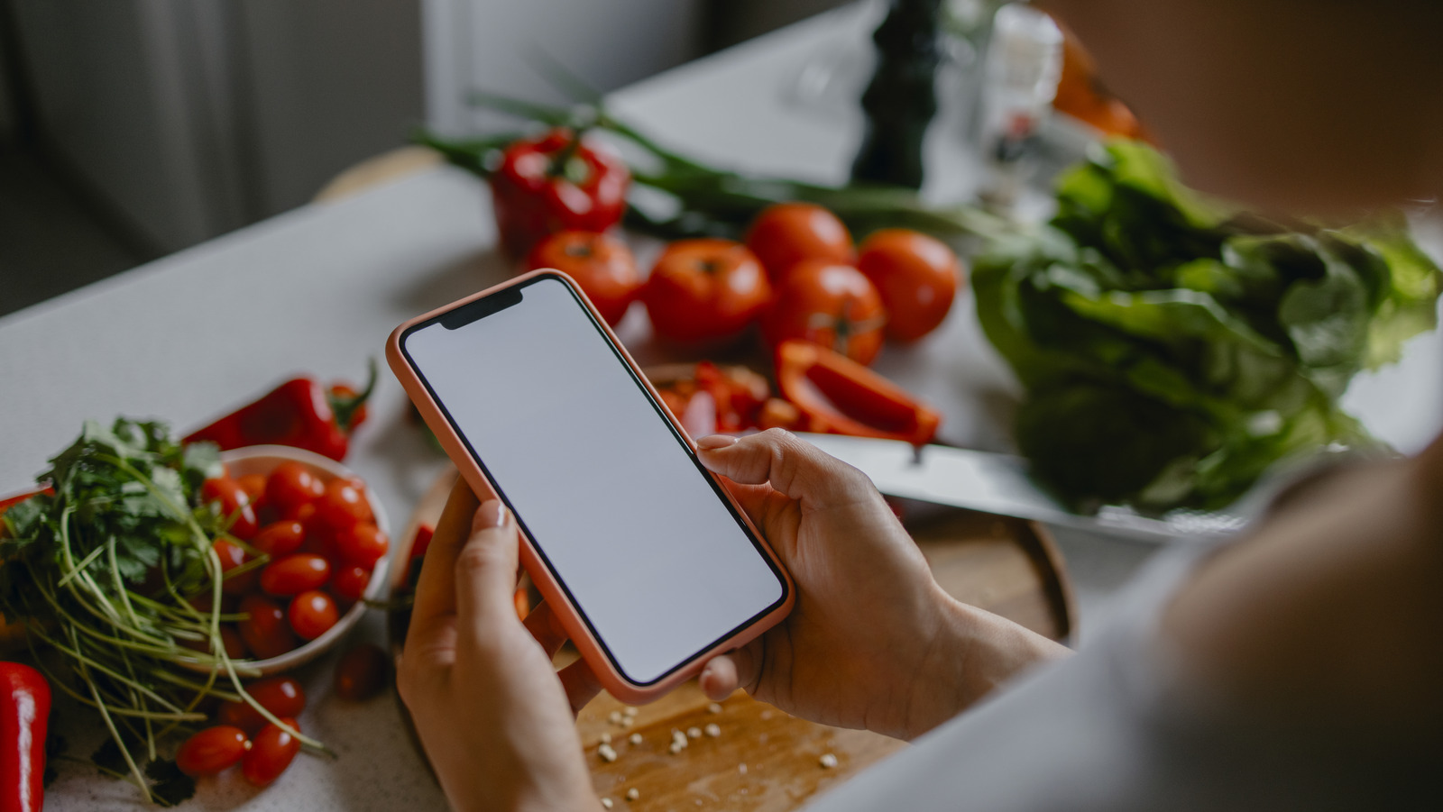Using Your Phone While Cooking Could Be A Major Food Safety Mistake