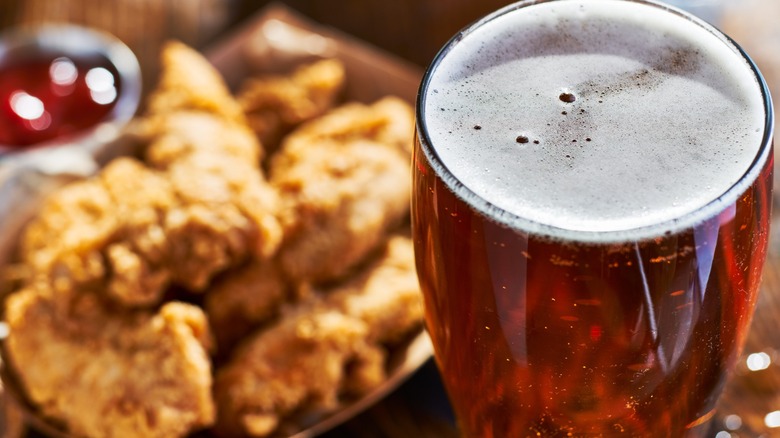 Why Drinking Beer Alongside A Plate Of Fried Chicken Tastes So Good